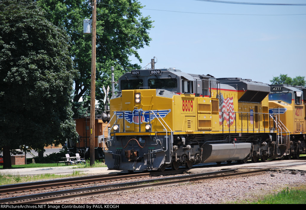 UP 8809 with UP 4277 lead a Car Train west through Rochelle on a Sunny Day.